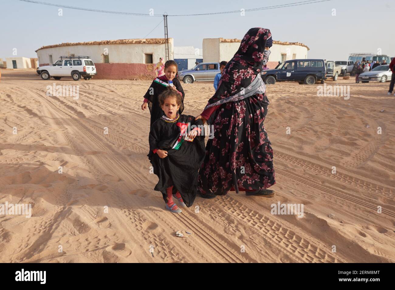 Sahrawis watch soldiers march in a parade during the celebrations ...