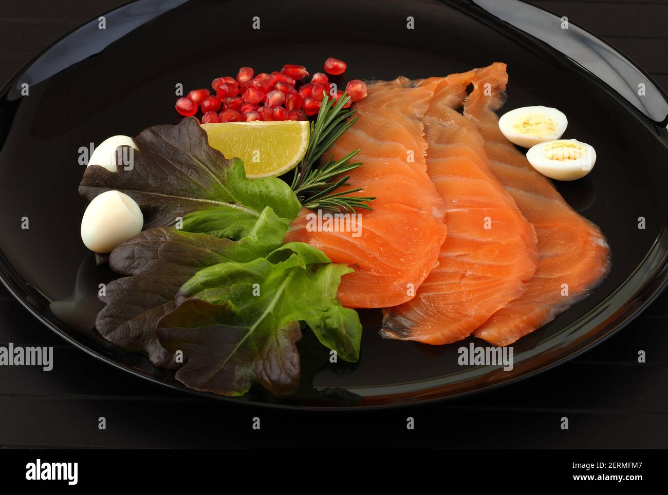 Salmon, sliced red fish with lime, rosemary and pomegranate seeds ...