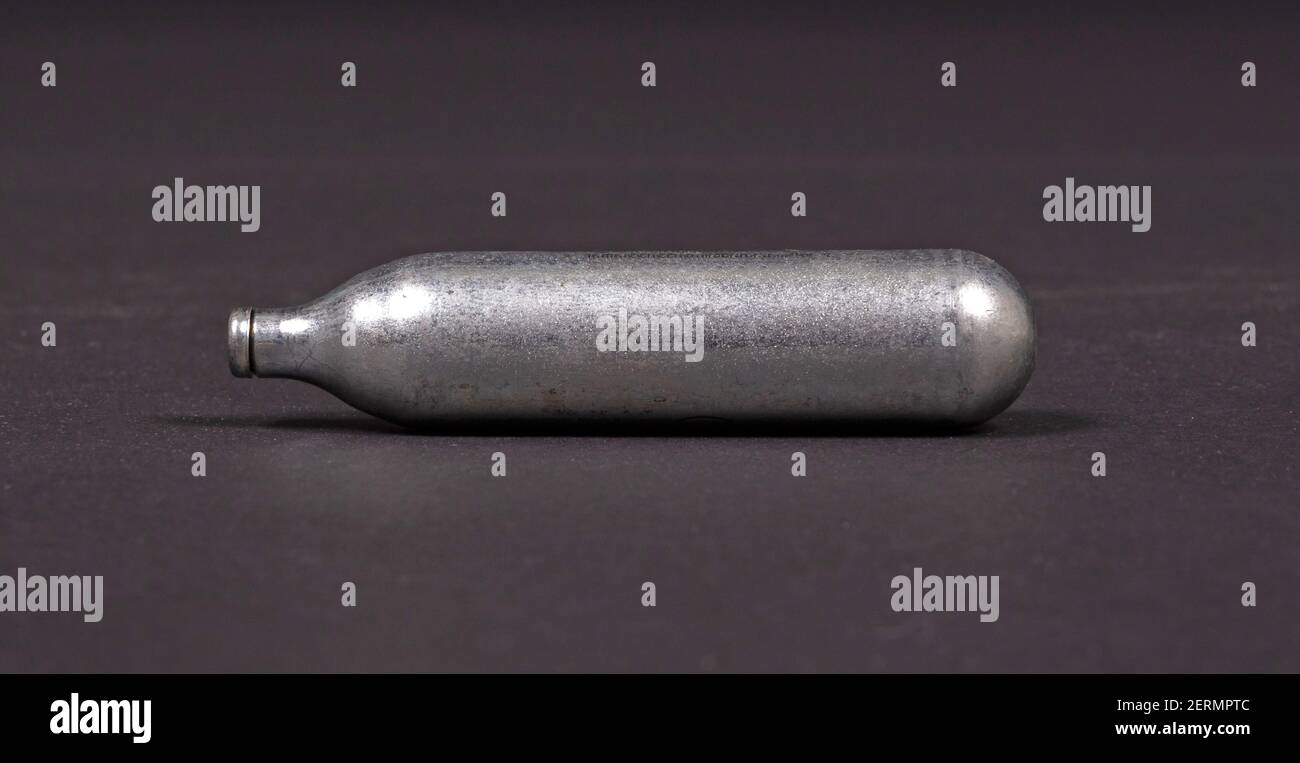 Empty canister of laughing gas, isolated on black Stock Photo - Alamy