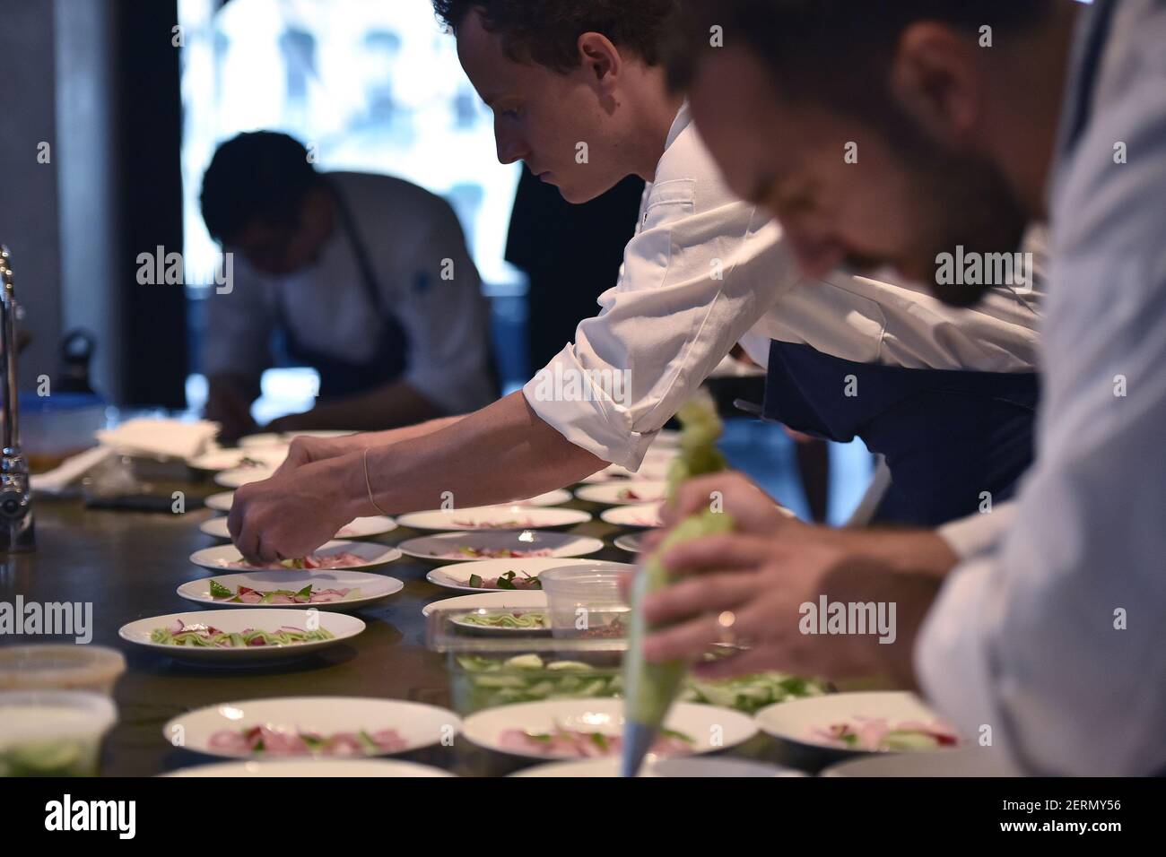 NEW YORK - SEPTEMBER 21: Chef's preparing meal for invited guests at ...