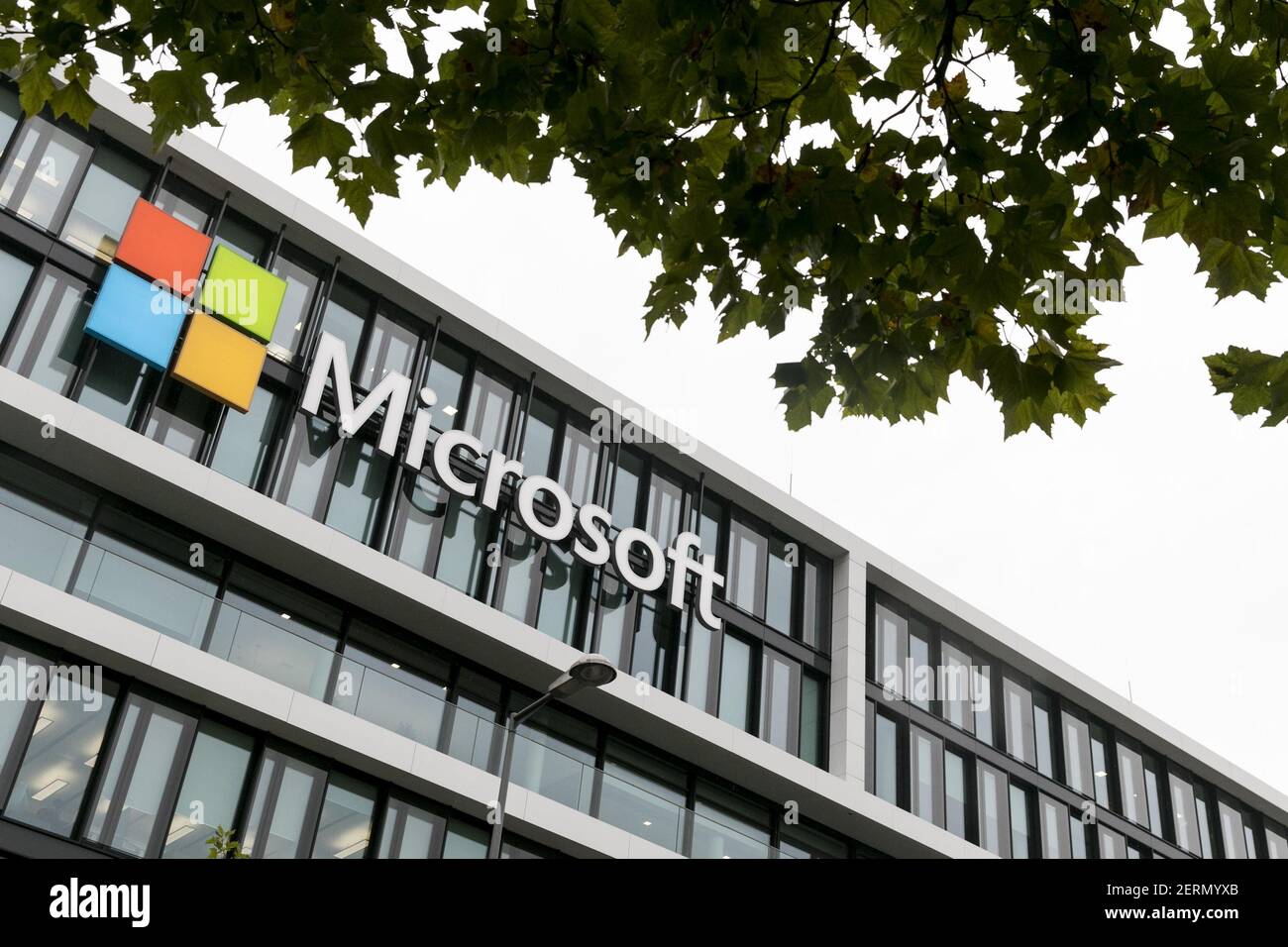 A logo sign outside of a facility occupied by Microsoft in Munich ...