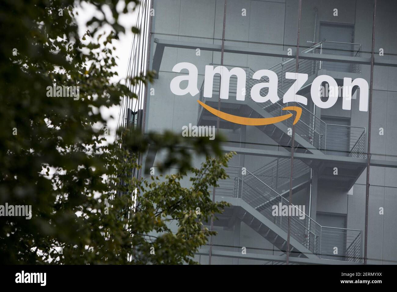 A logo sign outside of a facility occupied by Amazon in Munich, Germany ...