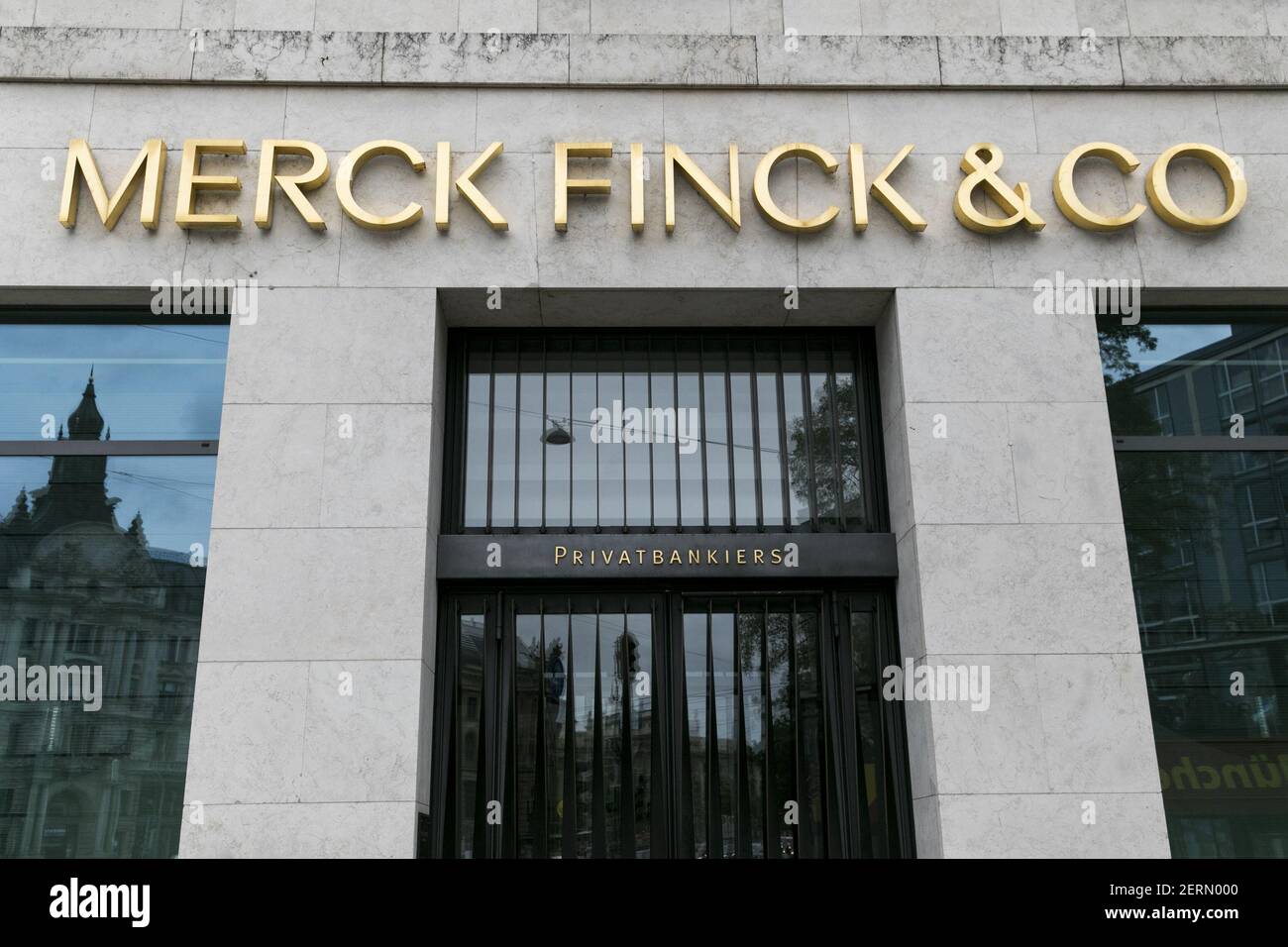 A logo sign outside of the headquarters of Merck Finck & Co., in Munich ...