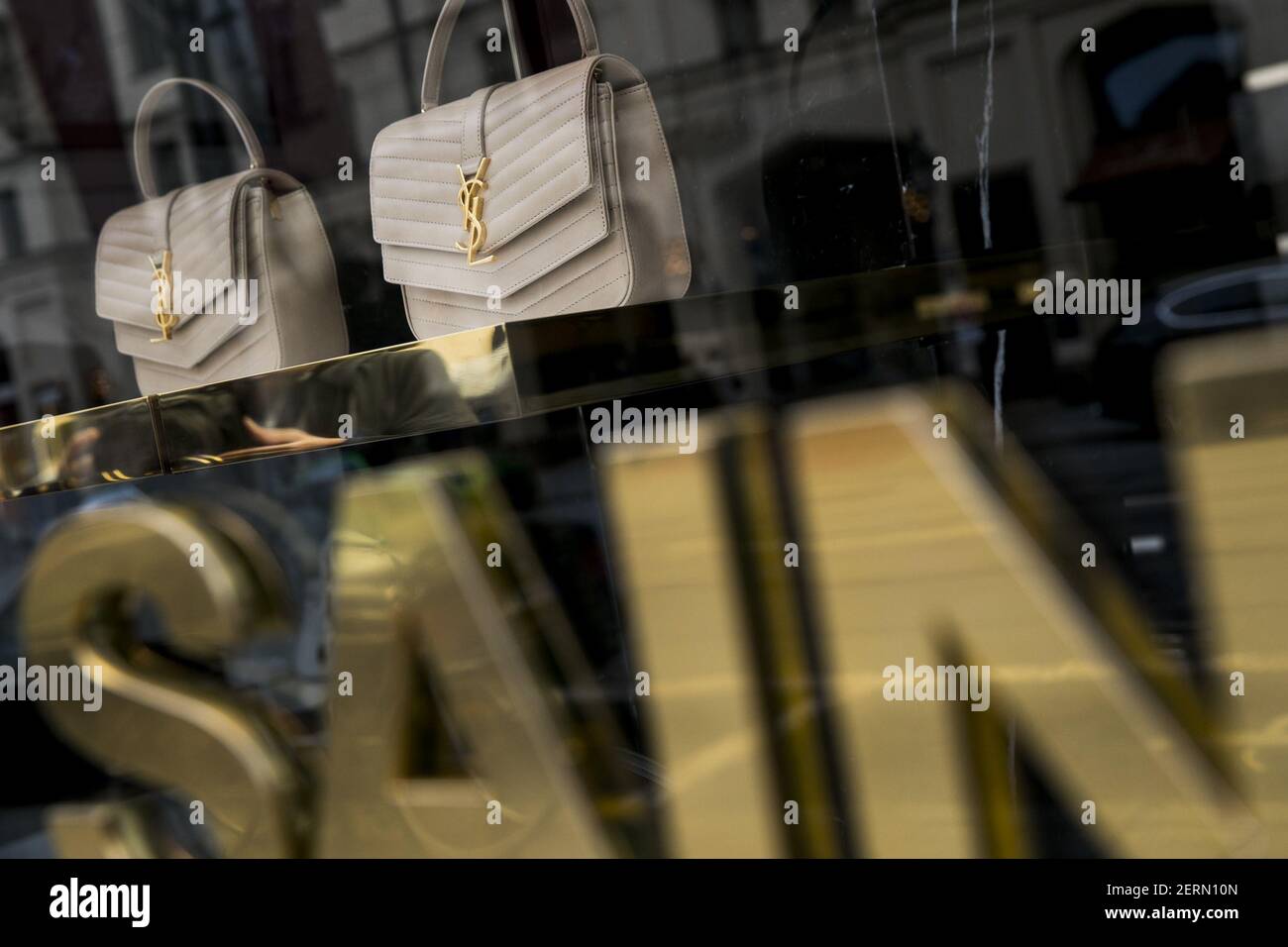 A logo sign outside of a Yves Saint Laurent retail store in Munich ...
