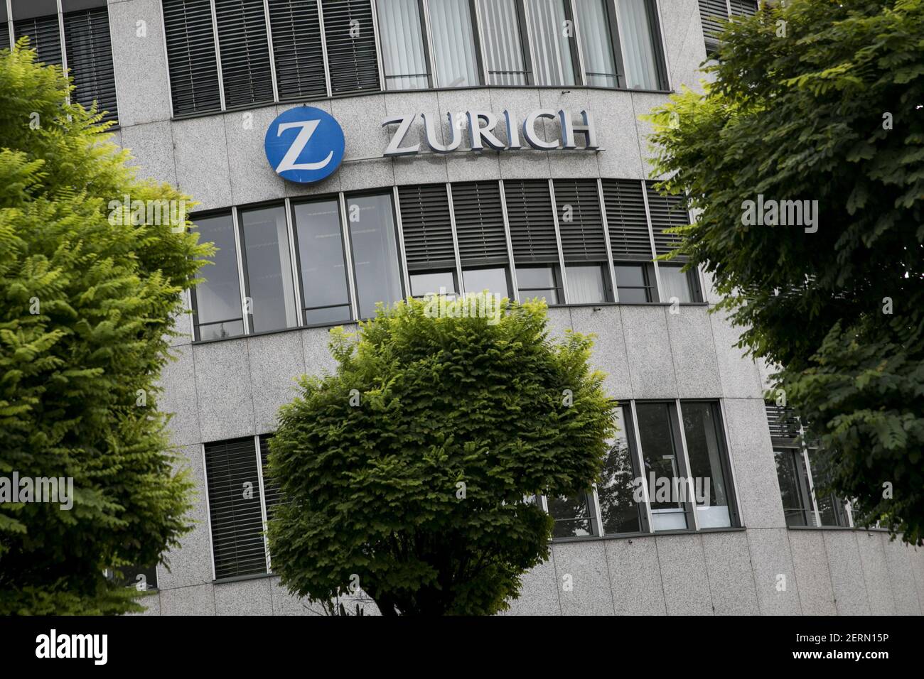 A logo sign outside of a facility occupied by the Zurich Insurance ...