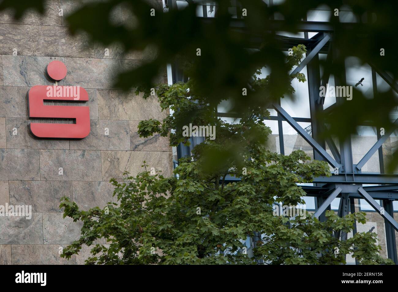 A logo sign outside of the headquarters of Stadtsparkasse München in ...