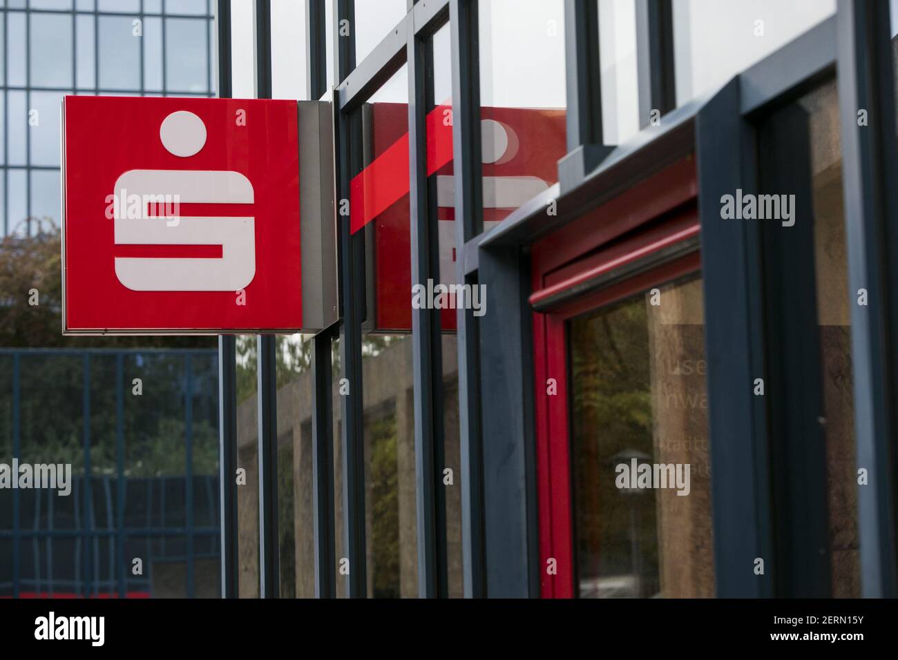 A logo sign outside of the headquarters of Stadtsparkasse München in ...