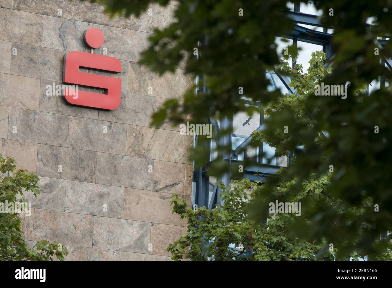 A logo sign outside of the headquarters of Stadtsparkasse München in ...