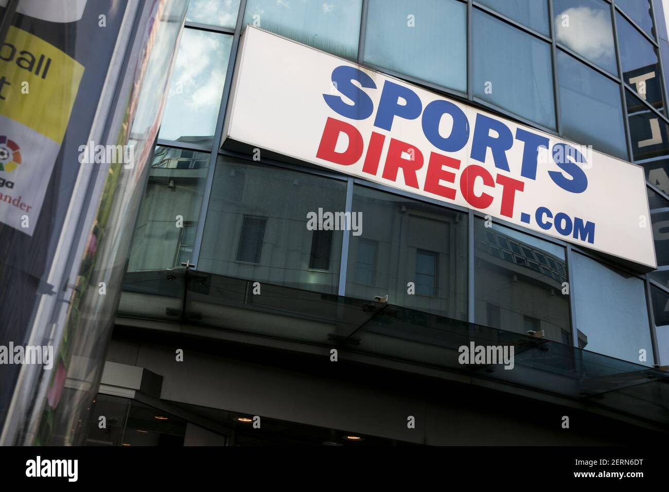 A logo sign outside of a Sports Direct International retail store in ...