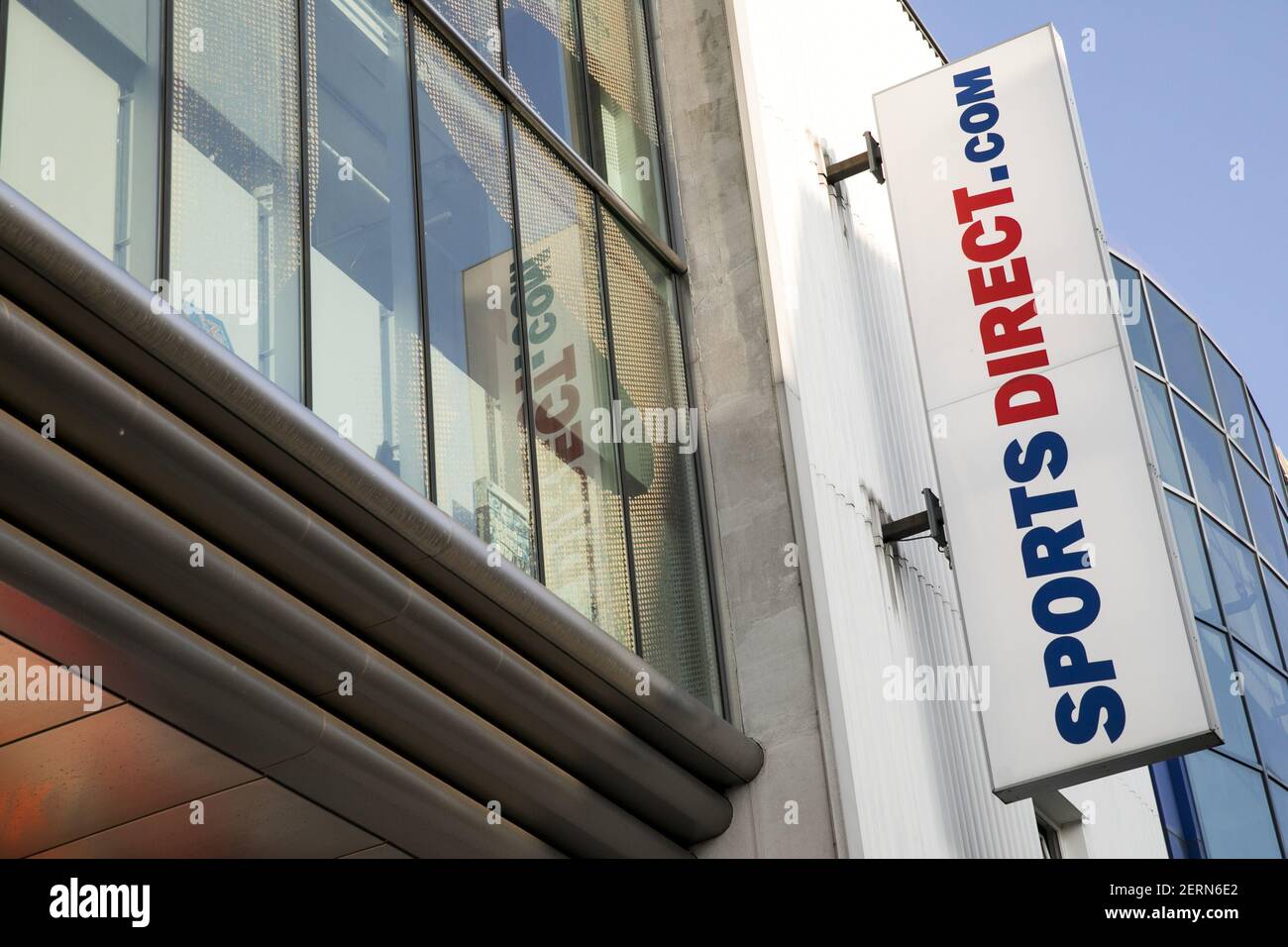 A logo sign outside of a Sports Direct International retail store in ...