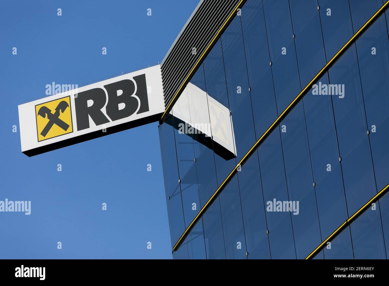 A logo sign outside of the headquarters of Raiffeisen Bank ...