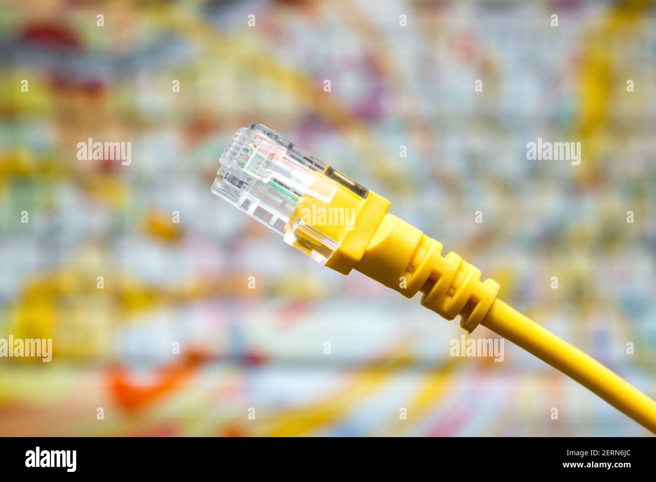 yellow network internet cable on a laptop background Stock Photo - Alamy