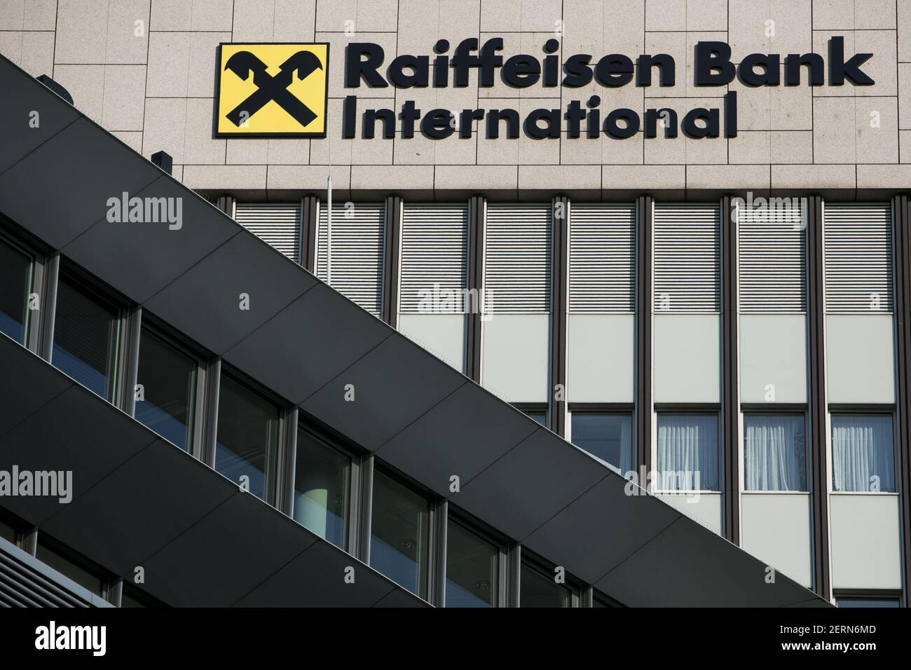 A logo sign outside of the headquarters of Raiffeisen Bank ...
