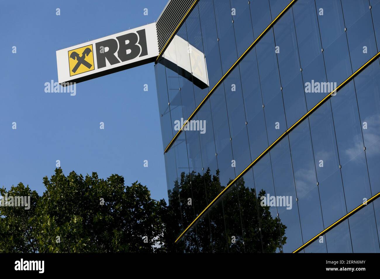 A logo sign outside of the headquarters of Raiffeisen Bank ...