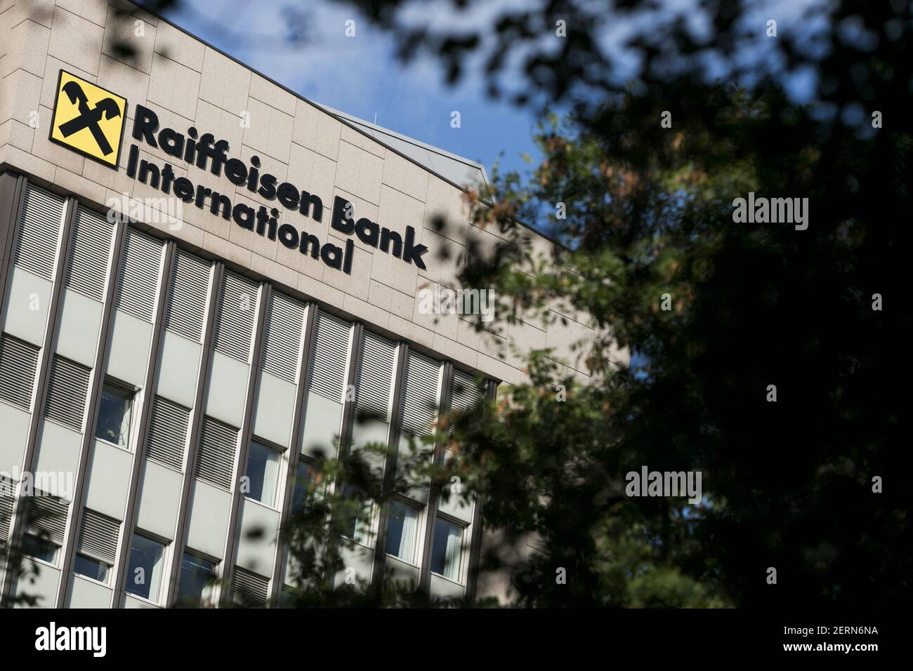 A logo sign outside of the headquarters of Raiffeisen Bank ...