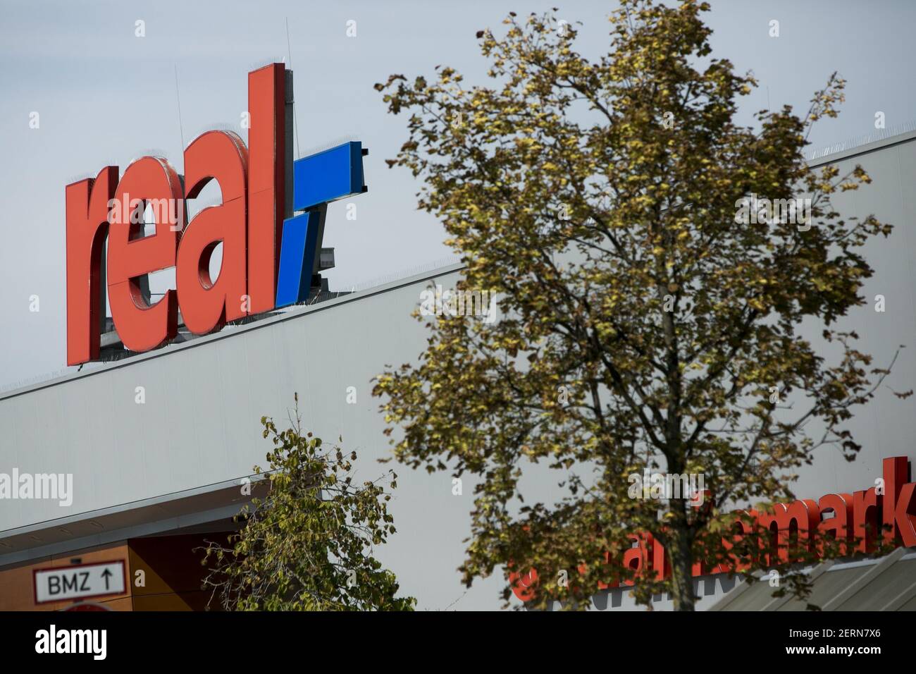 A logo sign outside of a Real (real,-) hypermarket retail store in ...