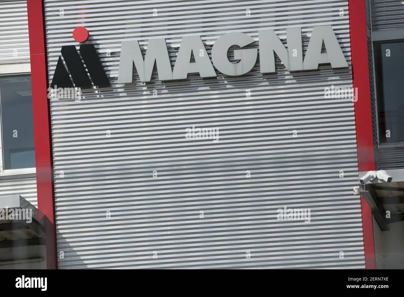 A logo sign outside of a facility occupied by Magna International Inc ...