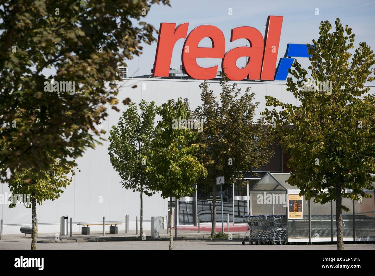 A logo sign outside of a Real (real,-) hypermarket retail store in ...
