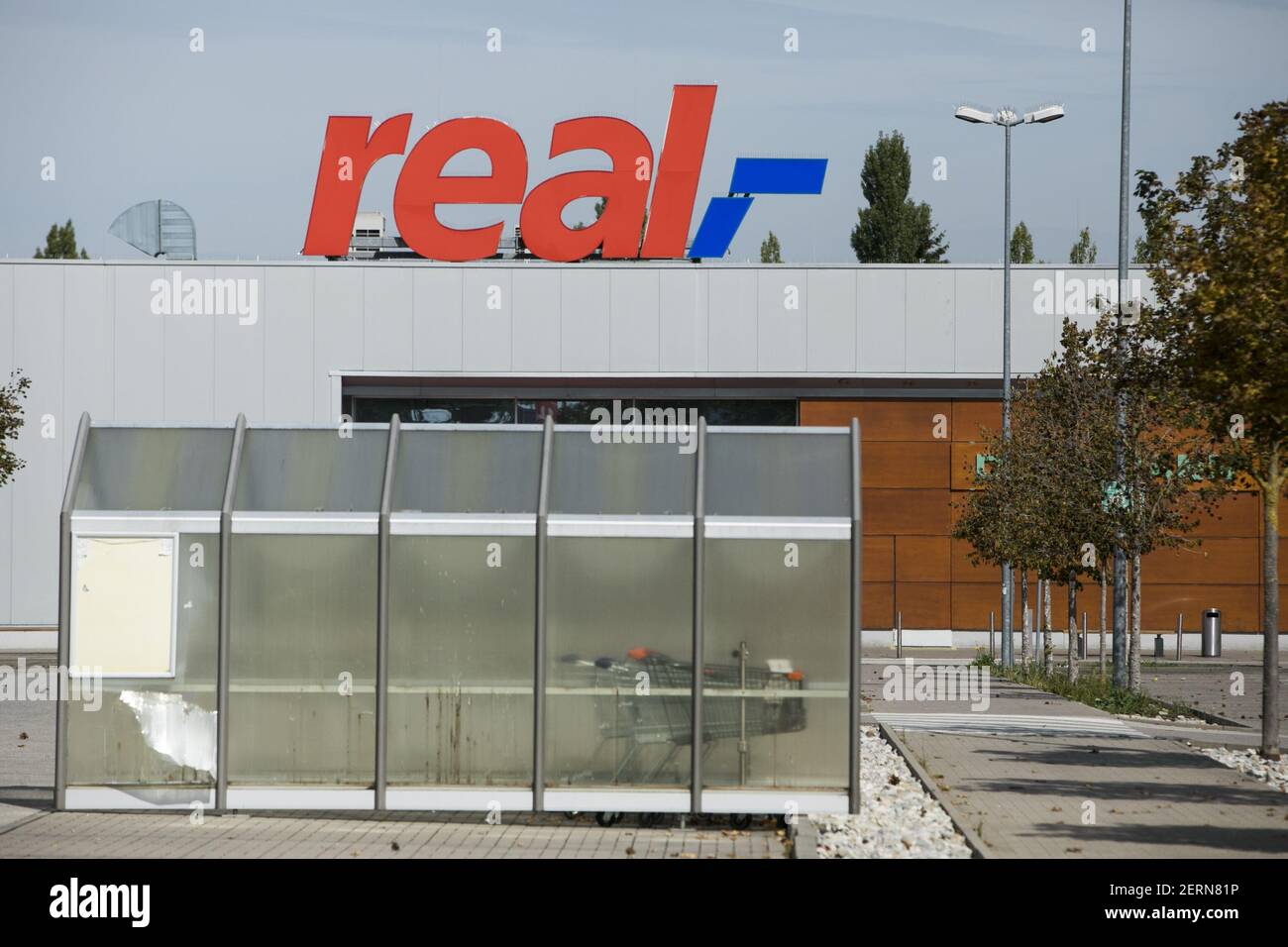 A logo sign outside of a Real (real,-) hypermarket retail store in ...