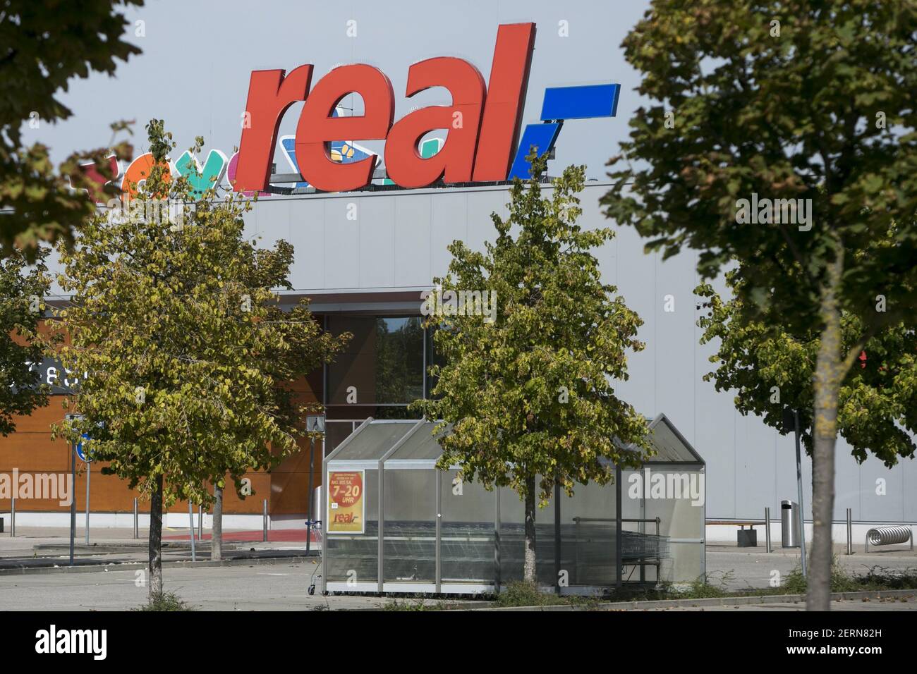 A logo sign outside of a Real (real,-) hypermarket retail store in ...