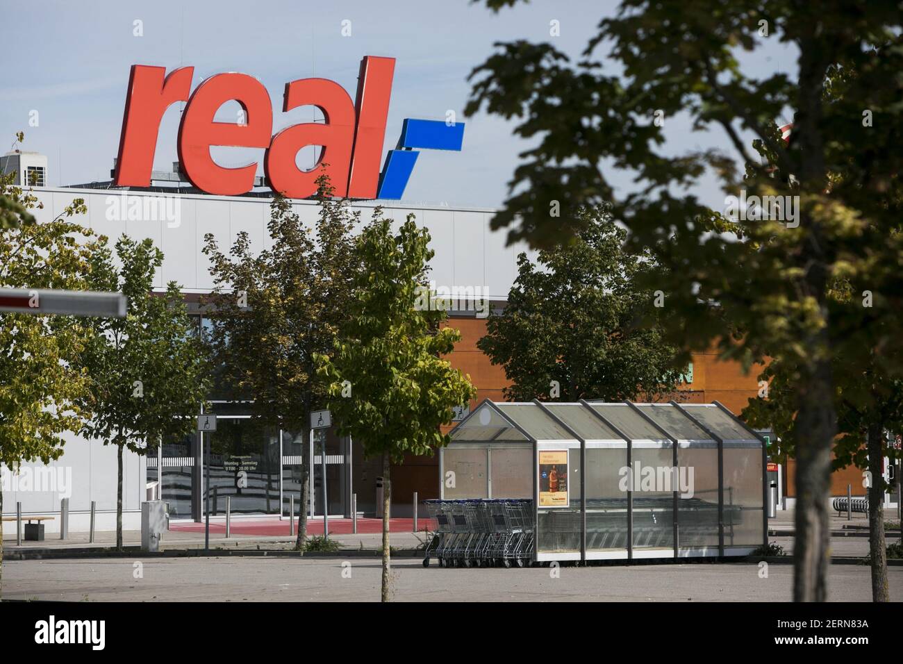 A logo sign outside of a Real (real,-) hypermarket retail store in ...