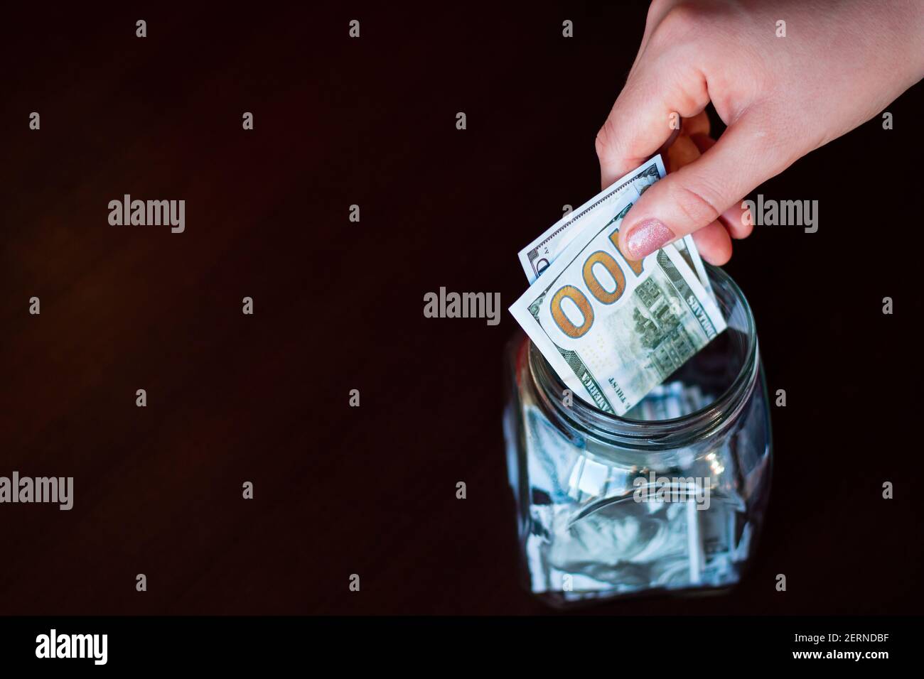 donation jar. gives money to charity with copy space on a dark ...