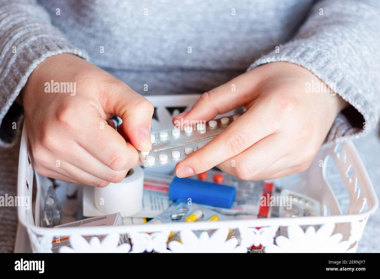 young woman pulls birth control pills from a first aid kit Stock Photo ...