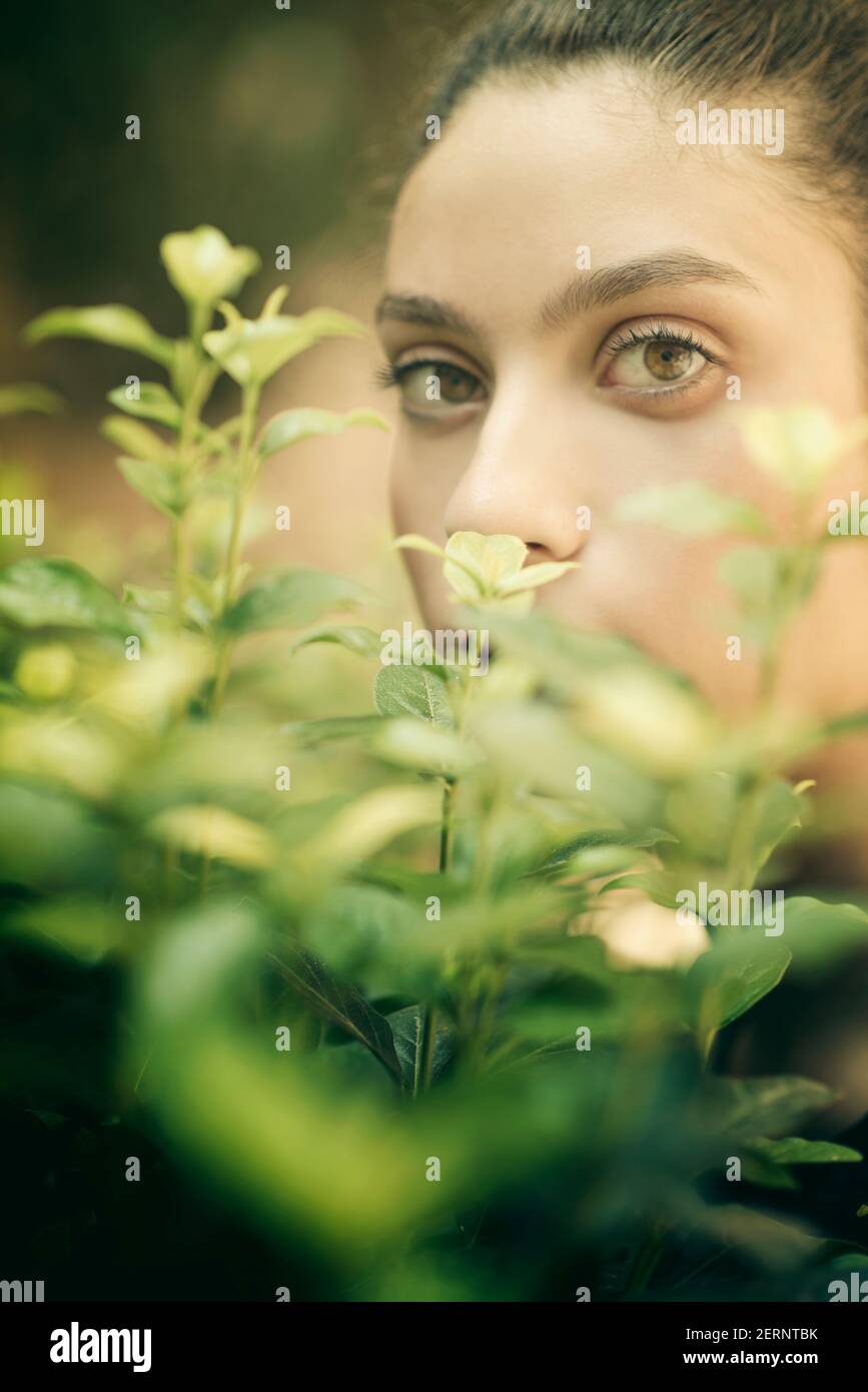 Female peeking through leaves hi-res stock photography and images - Alamy