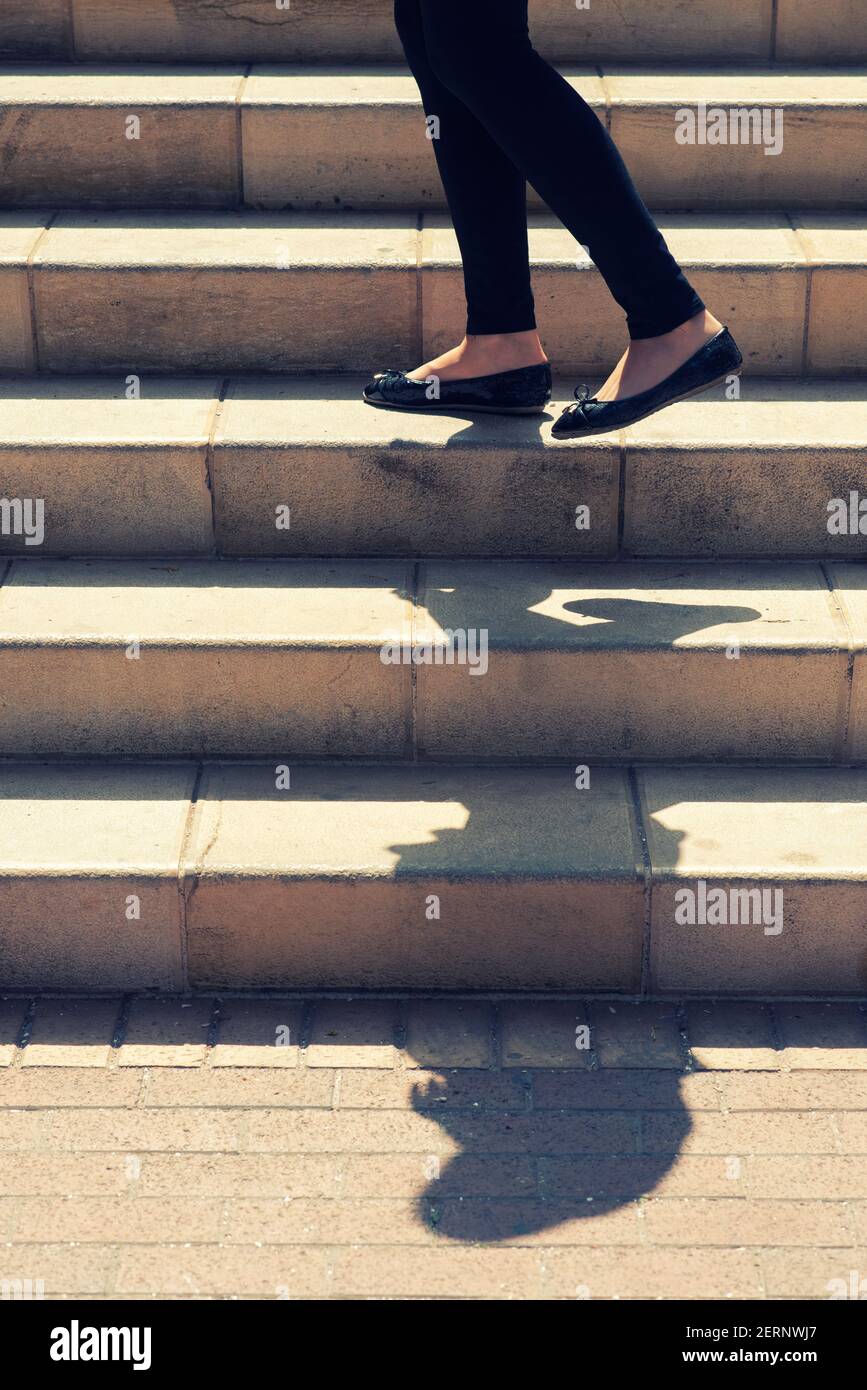 Walking down stairs side view hi-res stock photography and images - Alamy