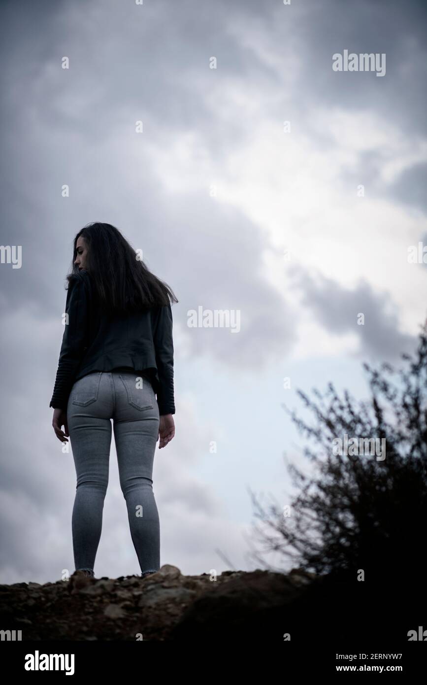 Rear view of woman standing outdoors Stock Photo - Alamy