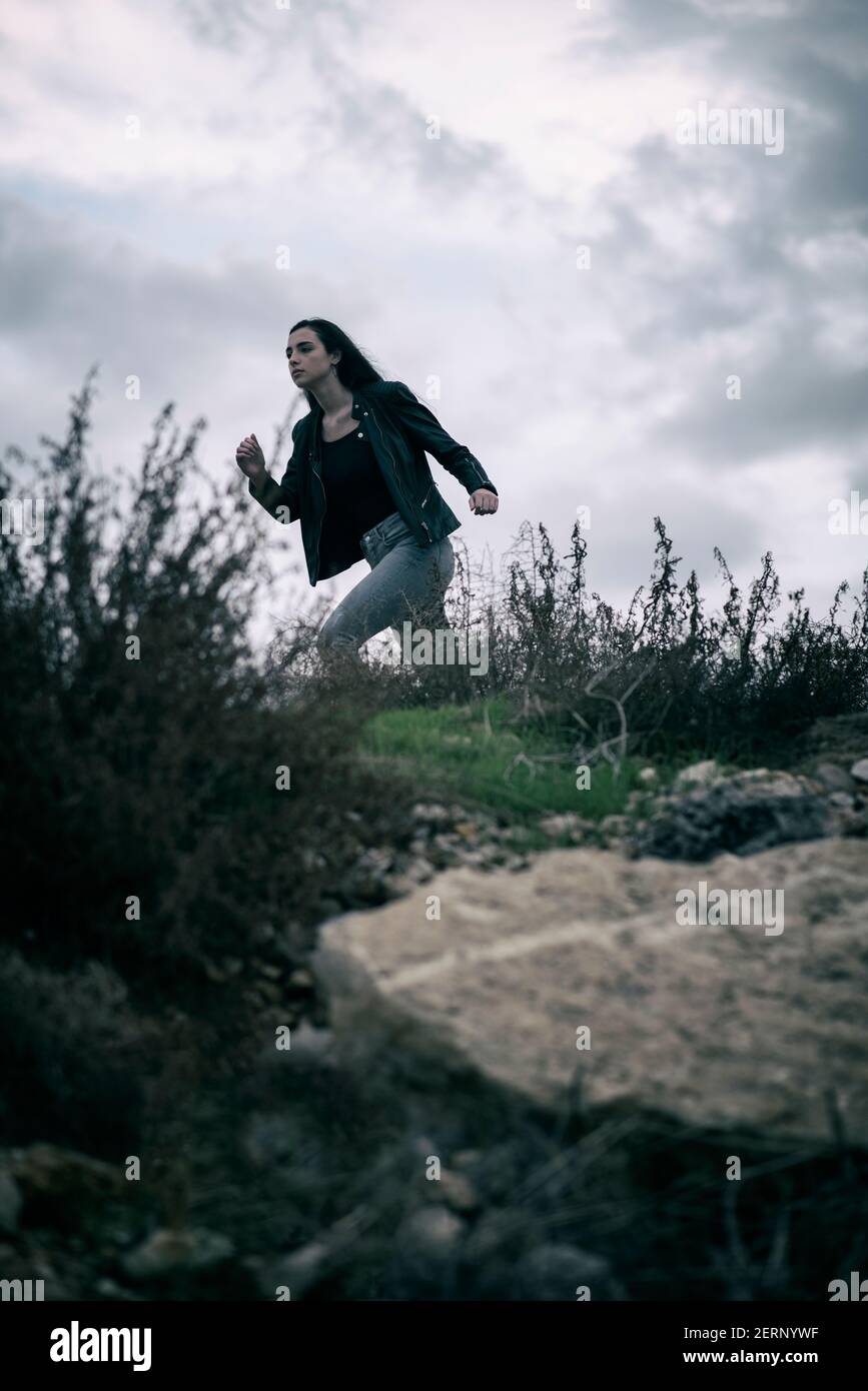 Young woman running away Stock Photo - Alamy