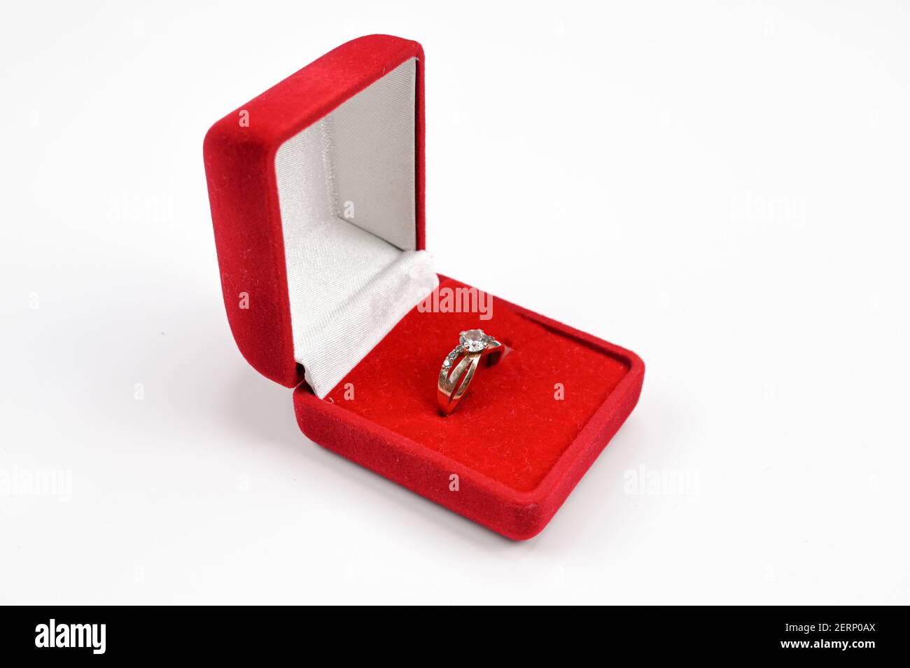 Jewelry ring with diamond in a red box, on an isolated white background ...