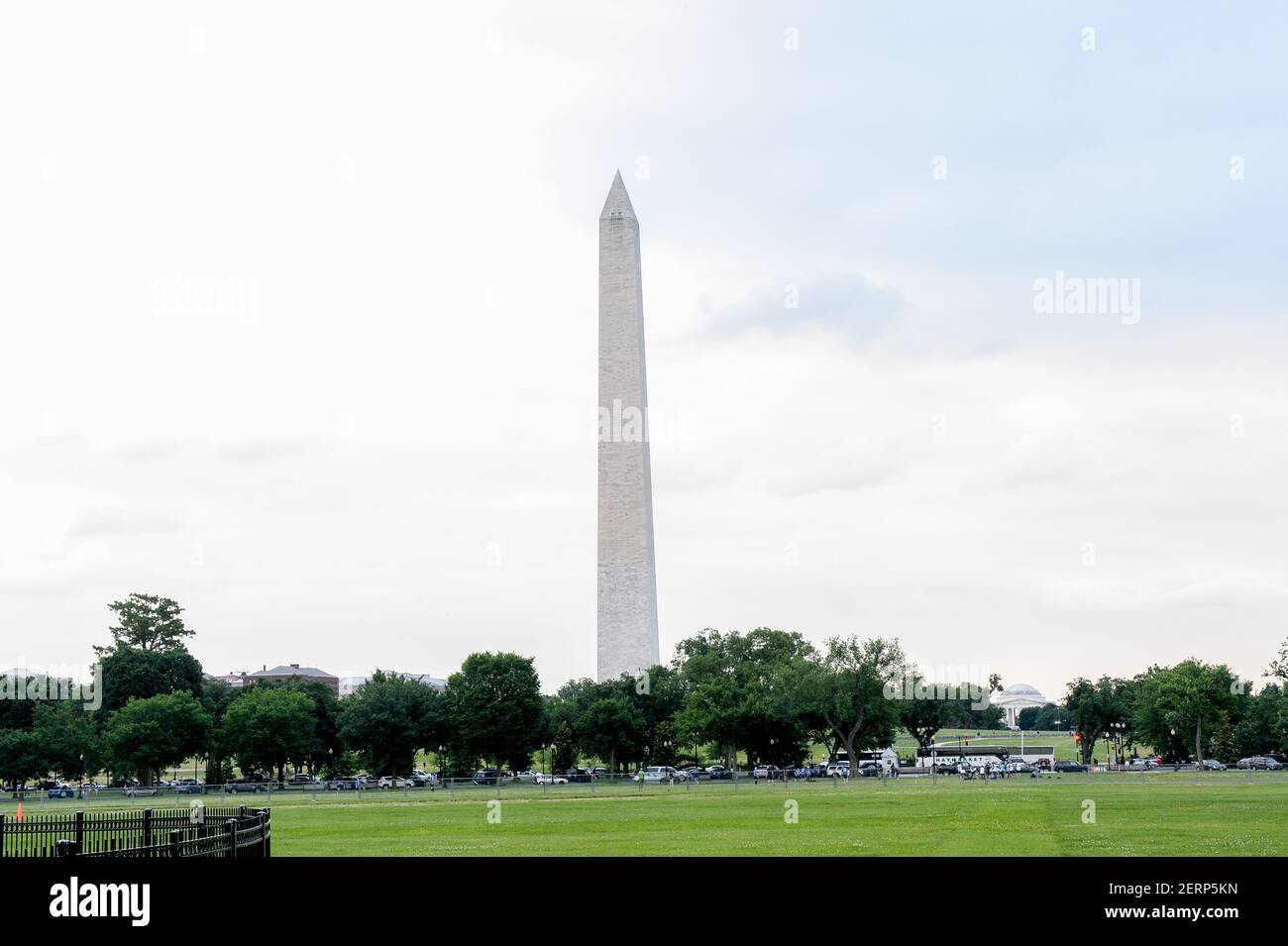 The Washington National Monument with U.S. flags in front the obelisk ...