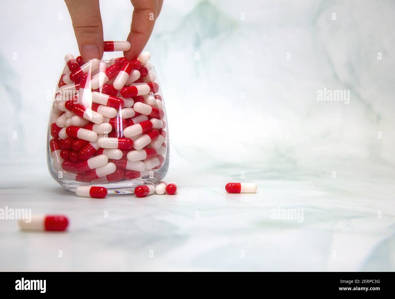 A hand grabbing hand full of medicines, Capsules for Vitamines,drugs ...