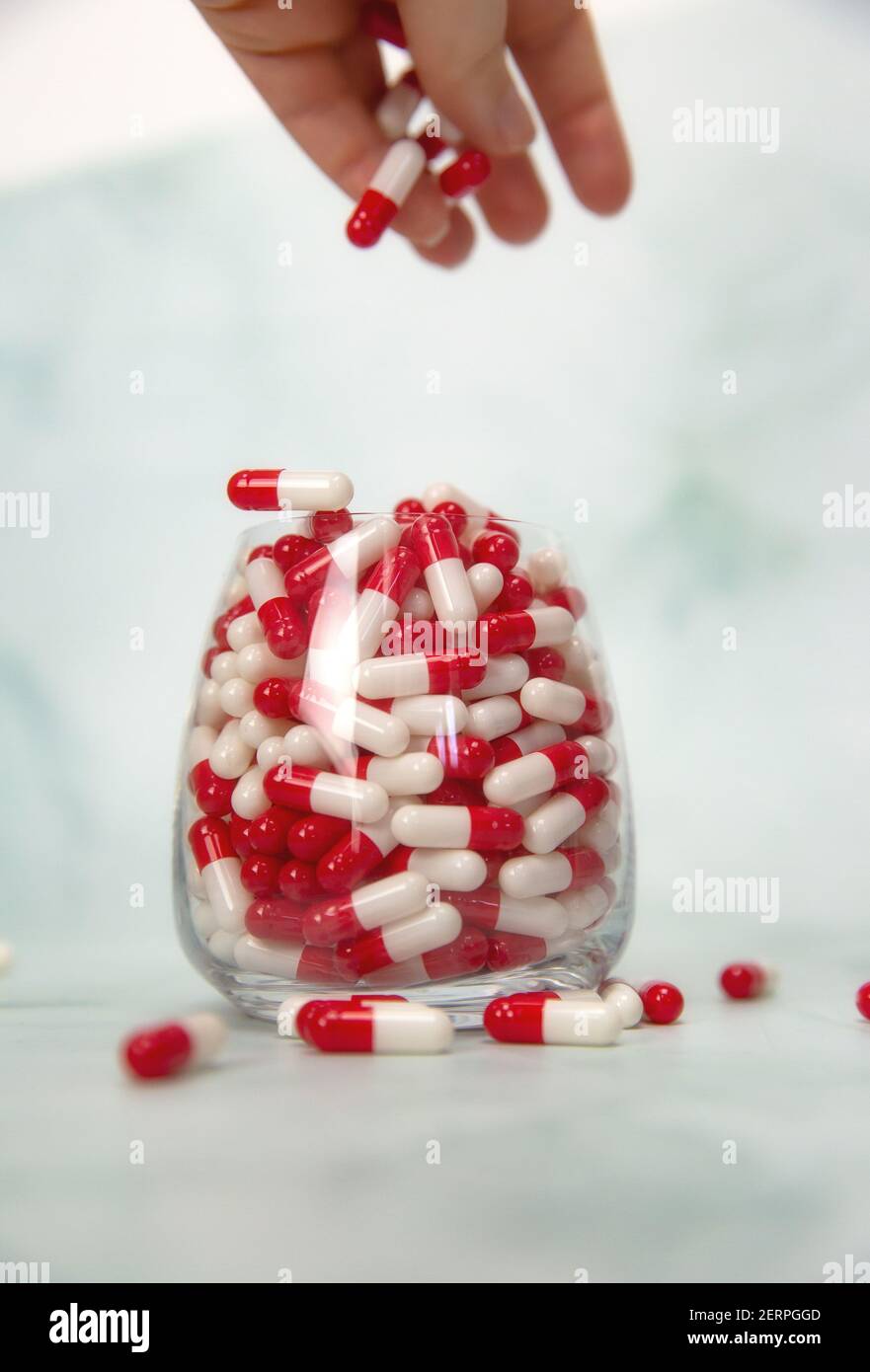 A hand grabbing hand full of medicines, Capsules for Vitamines,drugs ...