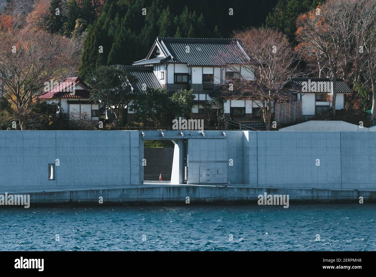 Old Tohoku's style house is seen behind a sea wall on November 23, 2020 ...