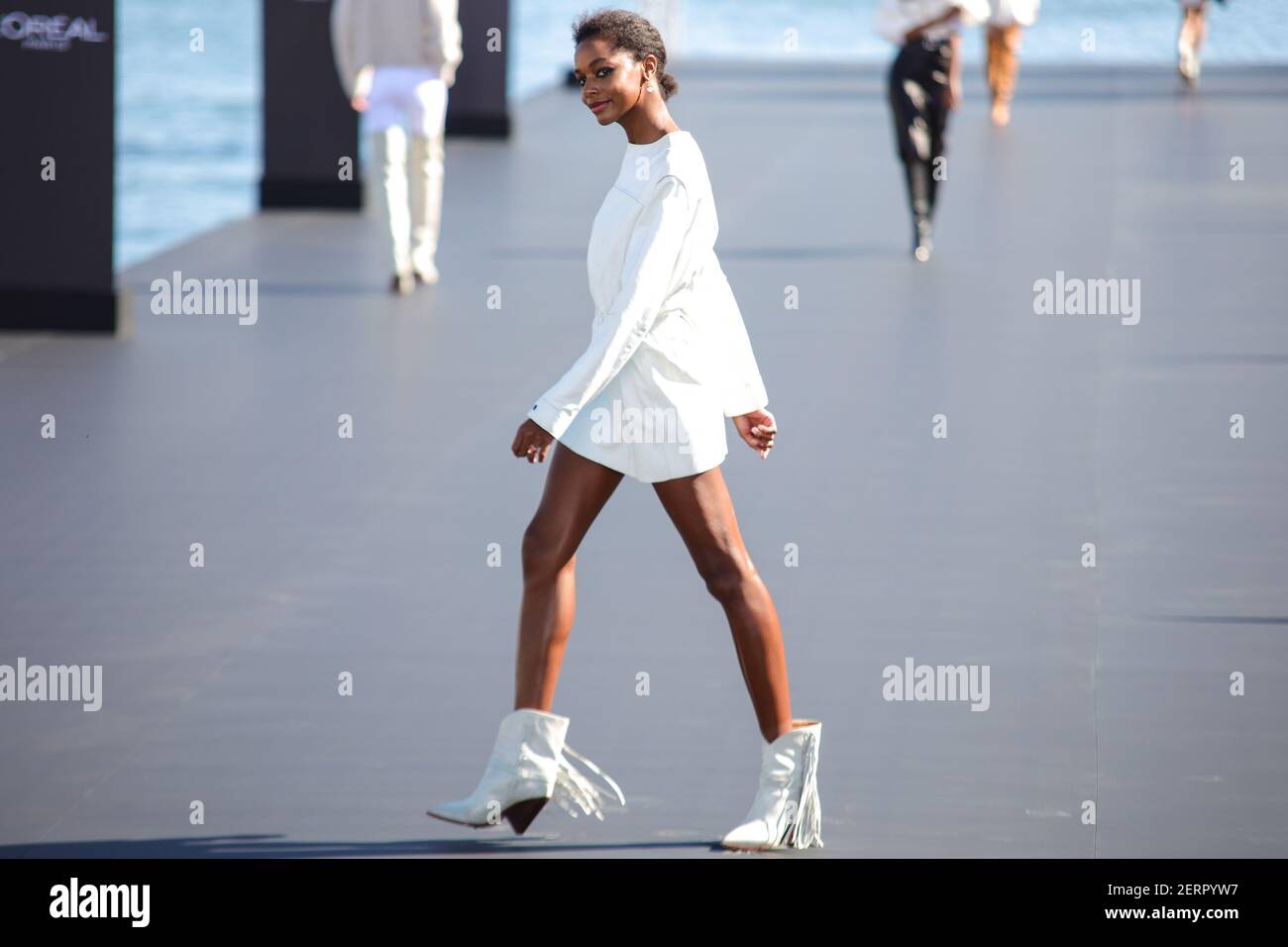 A model walks the L'Oréal Fashion Show runway during Paris Fashion Week ...