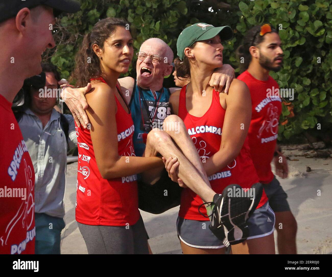 Michael Allen of "Team Special Compass," center, is helped into his ...