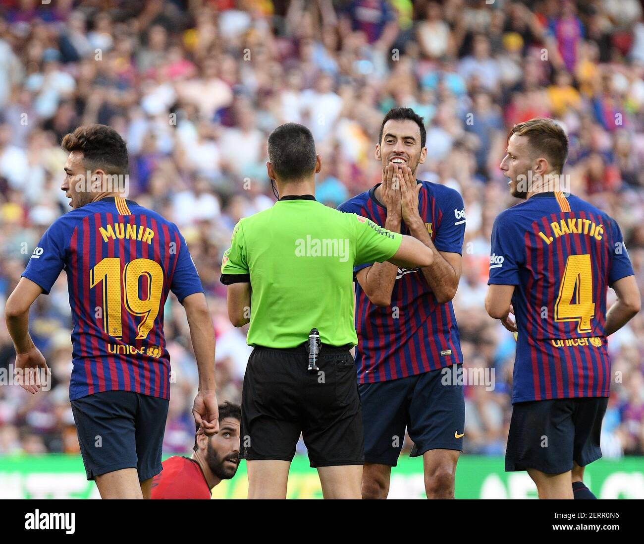 The referee teaches yellow card to Sergio Busquets of FC Barcelona ...