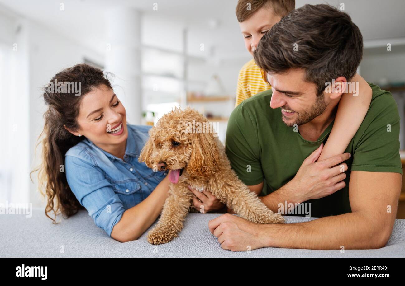 Portrait of happy family with a dog having fun together at home Stock ...
