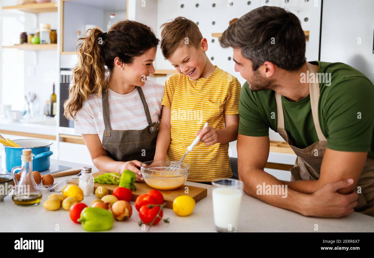 Happy family in the kitchen having fun and cooking together Stock Photo ...