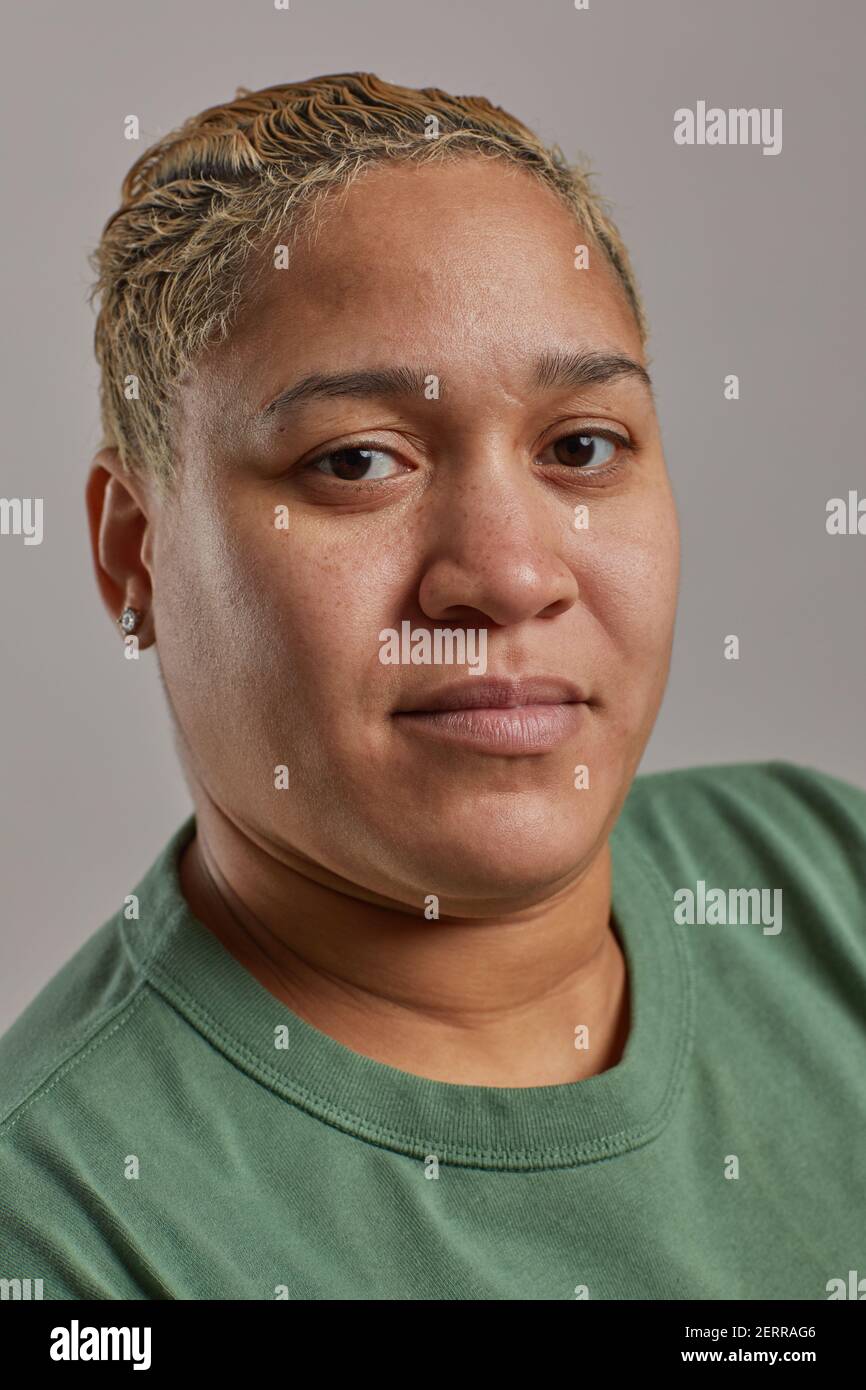 Vertical close up portrait of androgynous mixed race woman looking at ...