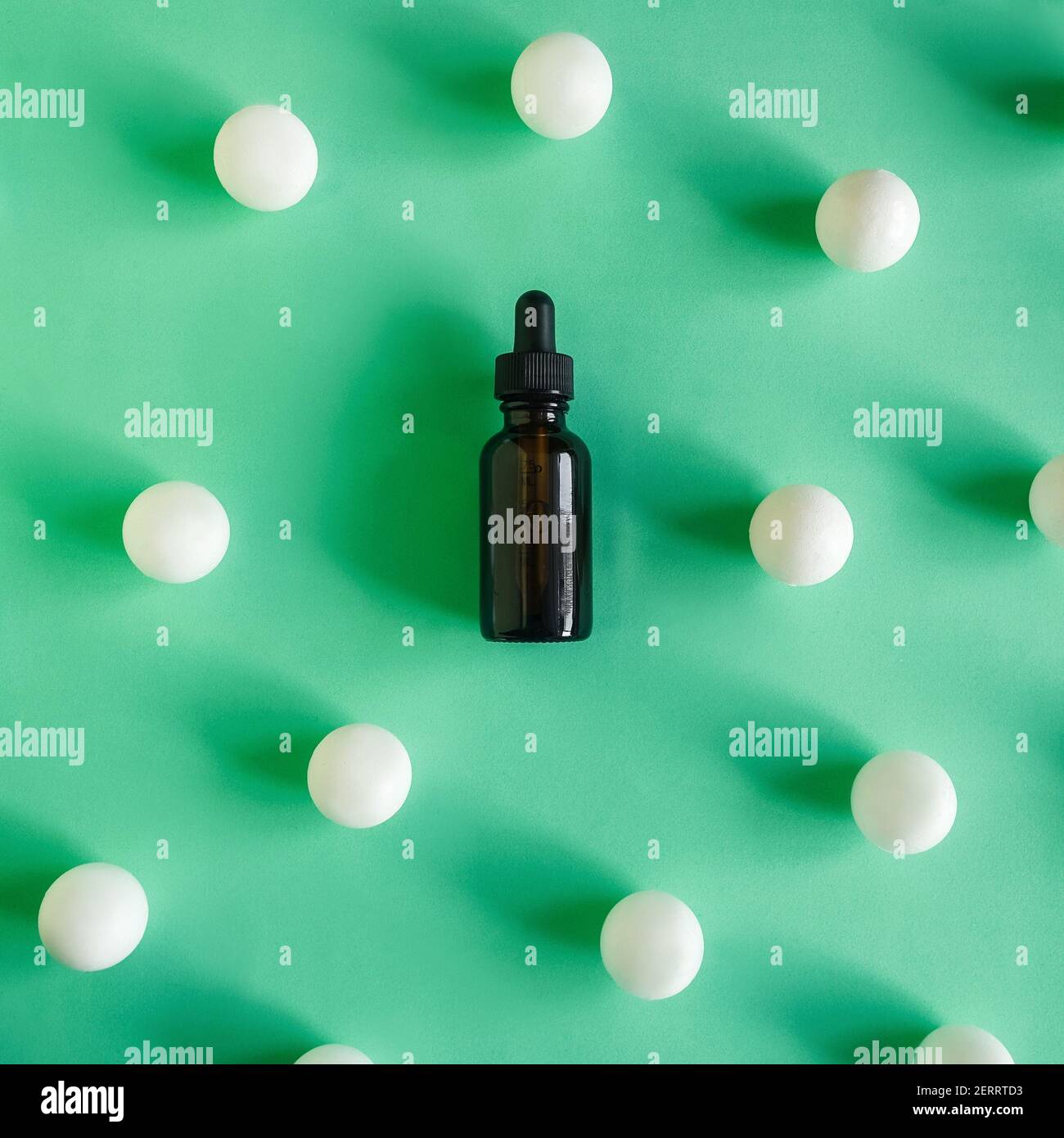 Blank amber glass face serum bottle on turquoise background. Abstract ...