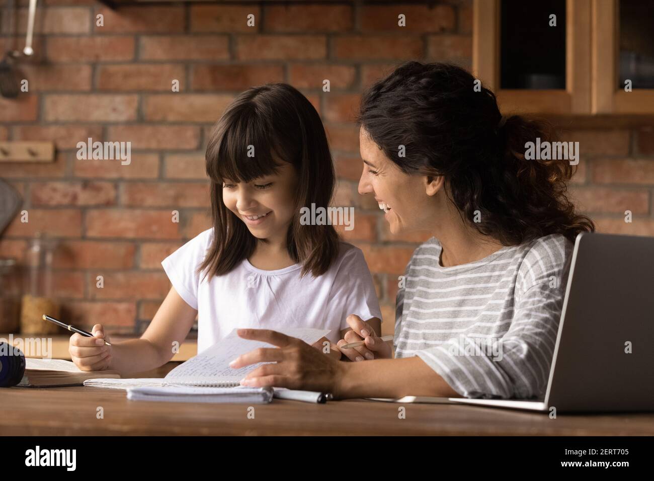 Girl doing homework with her mom hi-res stock photography and images ...