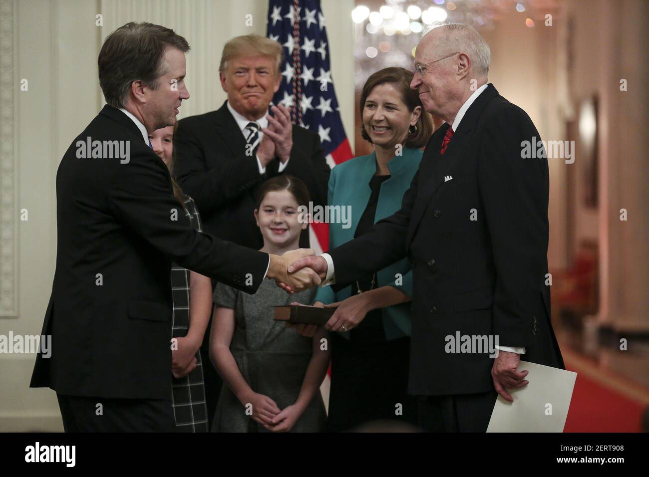 Supreme Court Justice Brett Kavanaugh, left, shakes hands with retired ...