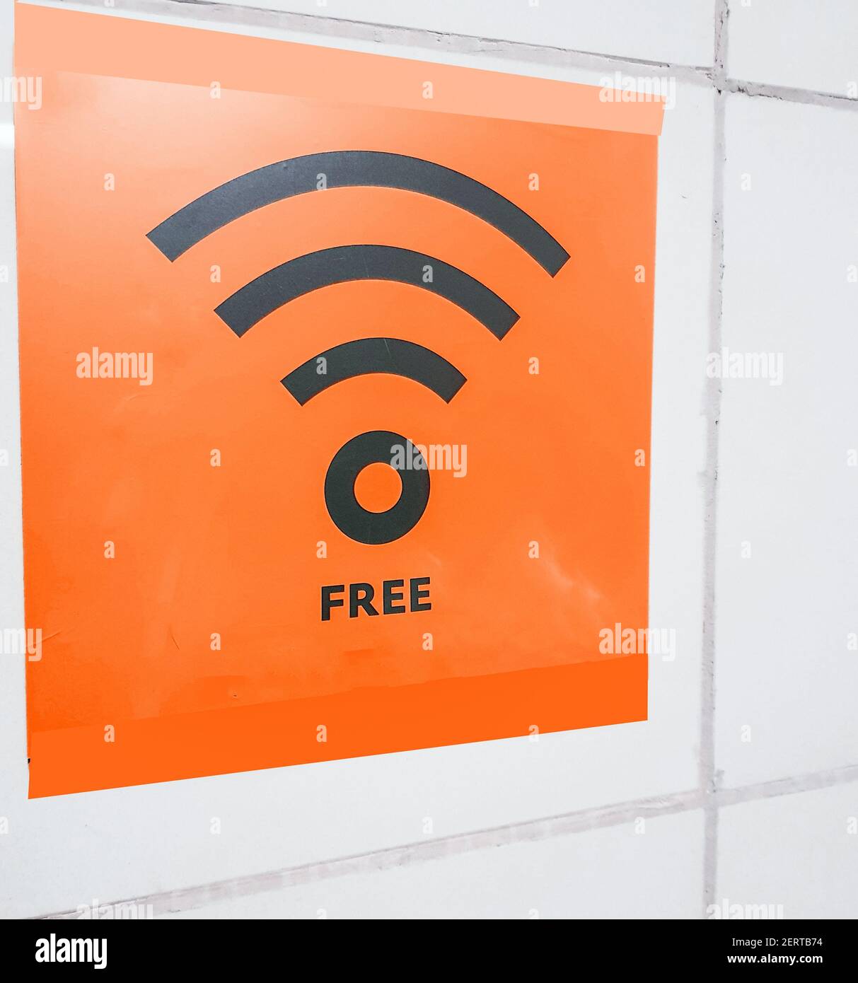 Free Wi-Fi zone symbol, orange sign on a white wall in a public empty ...