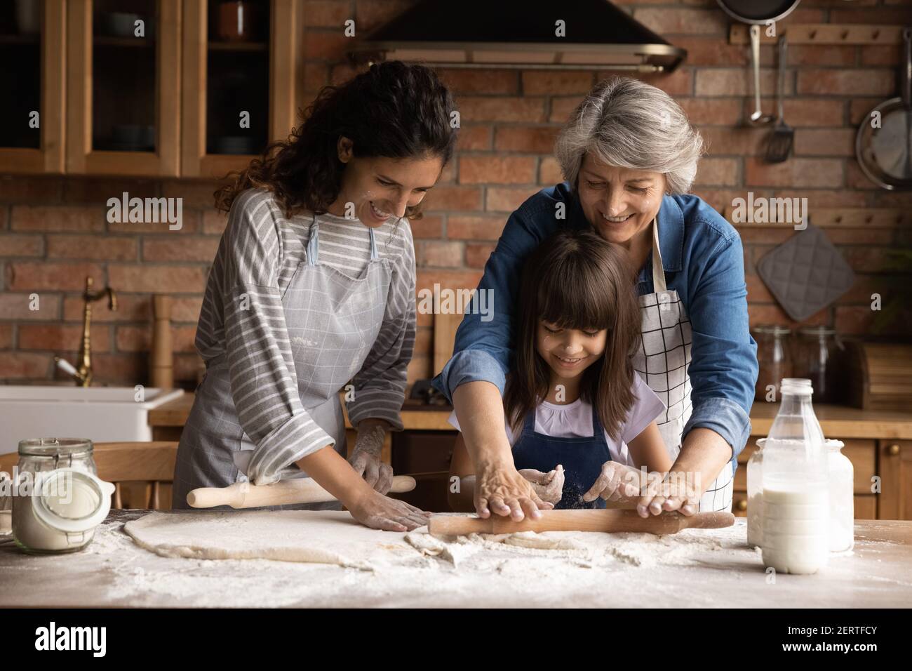 Happy three generations of women bake together Stock Photo - Alamy