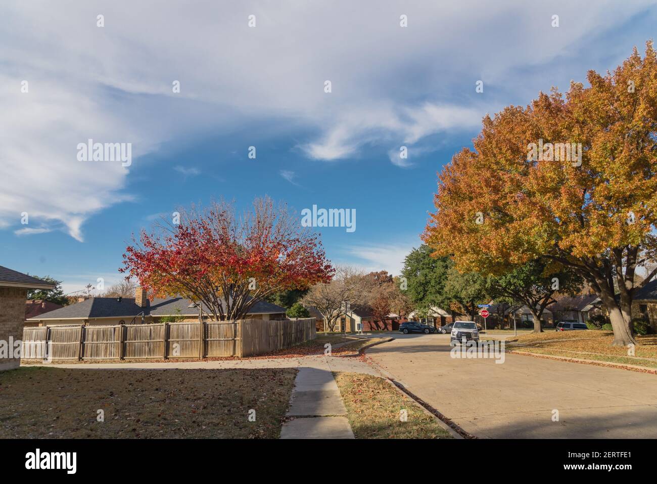 Empty sidewalk and quite neighborhood street with row of suburban house ...