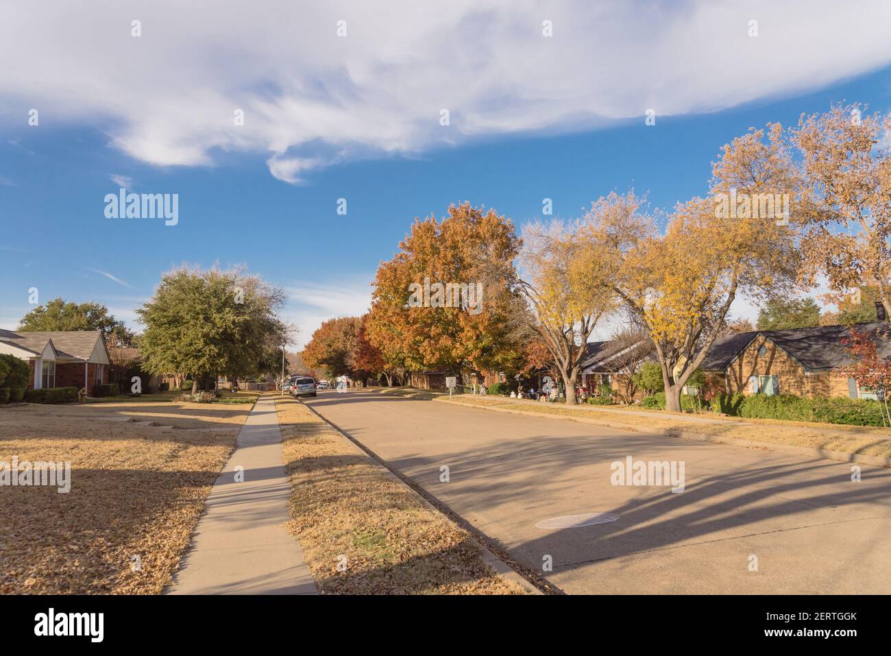 Empty sidewalk and quite neighborhood street with row of suburban house ...