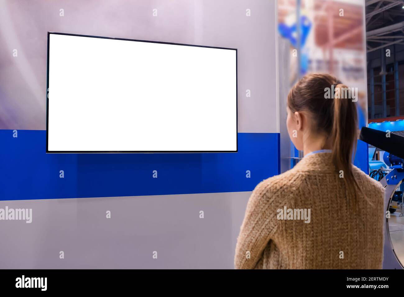 Woman looking at blank white display wall at exhibition - white screen ...